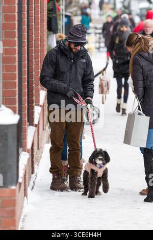Man walking small brown dog on sidewalk along West Colorado Avenue ...