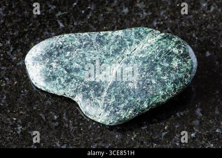 specimen of natural tumbled actinolite rock cutout on white background ...