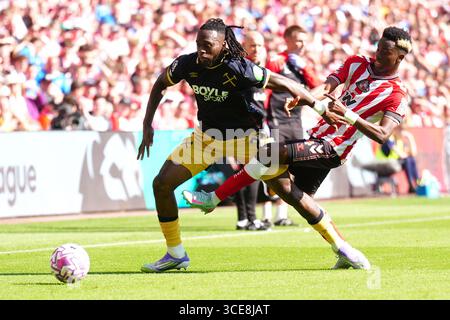 Sunderland's Simon Adingra in action Matheus Nunes of Manchester City ...