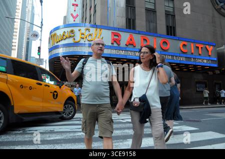 People walk past Radio City Music Hall in Manhattan, New York City ...