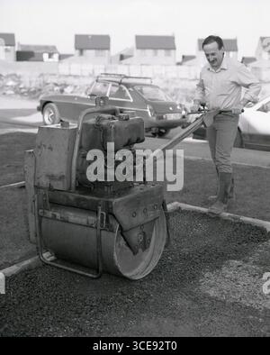 1980s, a man using a mechanical roller to flatten or compact down newly ...