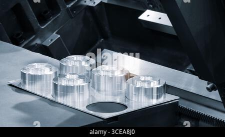 Row of metal cylinders are lined up in a row. The cylinders are all the ...