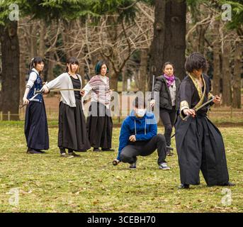Group of Japanese people practicing choreographed sword fighting in ...