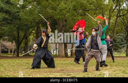 Group of Japanese people practicing choreographed sword fighting in ...