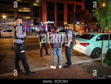 FBI agents, HSI police officers, and DEA agents stand behind a police ...