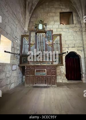 A pipe organ and stone columns with carvings in a church Stock Photo ...
