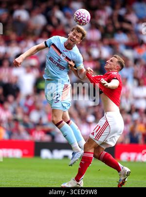 Brentford's Nathan Collins (left) and Nottingham Forest's Chris Wood ...