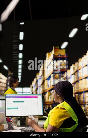 African American worker applying airway bill details and scanning ...