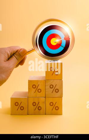 3D. hand holding magnifying glass and coins, graph on a mobile phone ...