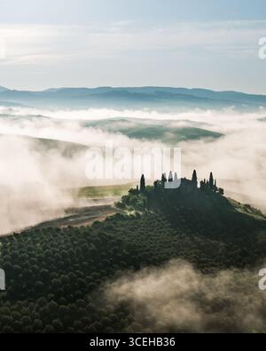 landscape of hilltop village shrouded in fog, Tuscan-Emilian Apennines ...