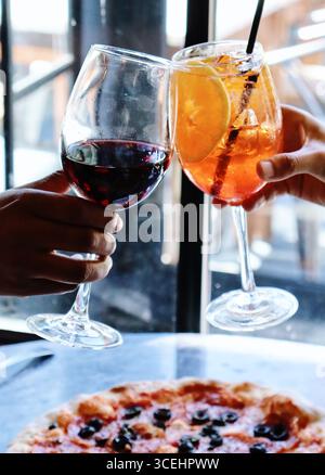 friends eating pizza and drinking red wine at home Stock Photo - Alamy