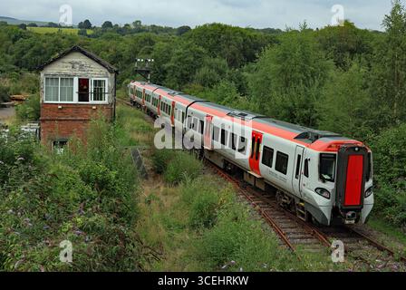 A Transport for Wales, TFW, train passes through Tal -y - Cafn Station ...