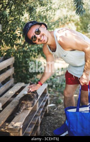 Person petting an adorable domestic cat Stock Photo - Alamy