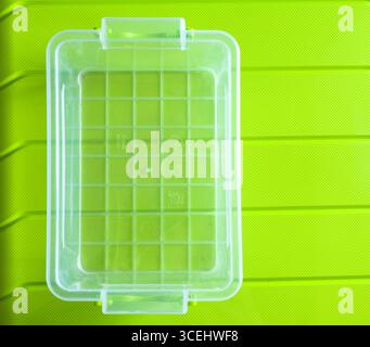 Plastic empty green box in the garden for plants or harvesting. On a ...