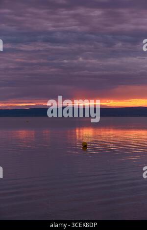 Buoy on a lake at sunset Stock Photo - Alamy