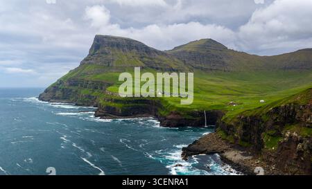 Beautiful view of a waterfall surrounded by cliffs Stock Photo - Alamy