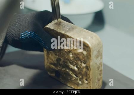 A gold bar that has been cleared of slag during solidification Stock ...