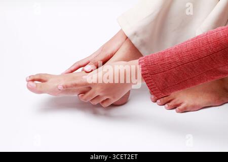 Problems with feet, woman's hands holding feet, foot joints and ankles ...