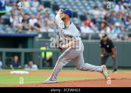 Texas Rangers starting pitcher Merrill Kelly winds up to deliver to the ...