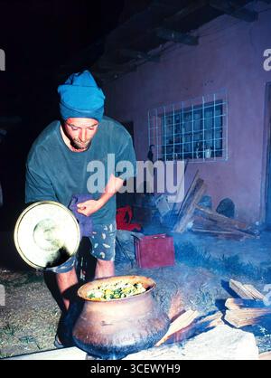 A huge pot of hot food being prepared over an open fire. Huaraz, Peru ...