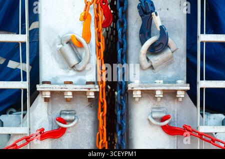 Multi-colored chains with hooks under tension hold the steel structures ...