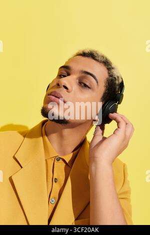 Portrait African american man listens music in autumn park copy space ...