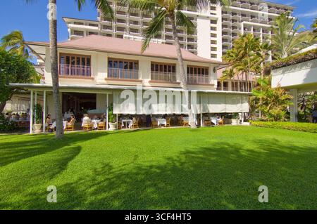 Orchids restaurant on the tropical grounds of the Halekulani Hotel ...