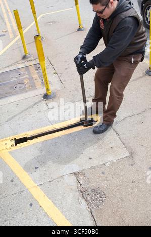 Cable car operator pulling lever to switch tracks, Powell Street, San ...