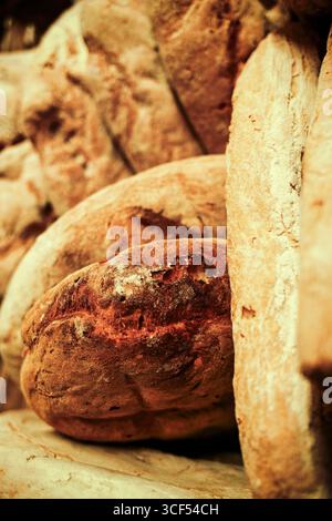 A closeup of fresh loaves of bread on the wooden surface Stock Photo ...