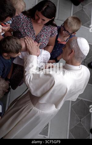 Pope Leo XIV greets a family during his weekly general audience in St ...