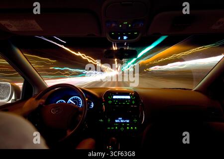Toyota Sienna Minivan driving at night with motion blur of lights along ...