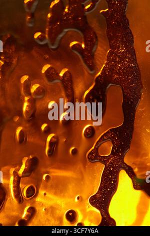 Abstract curved amber glass surface with vertical lines minimal design ...