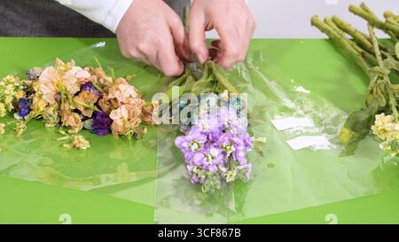 Aligning floral bouquet on wrapping paper Stock Photo - Alamy