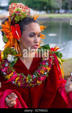 Beautiful female Pa’u rider adorned with flowers in hair on horseback ...