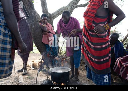 Maasai Men Cooking in Village, Tanzania Stock Photo - Alamy