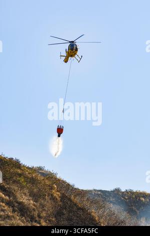 Honolulu Fire Department helicopter MD-520N flying with long line water ...