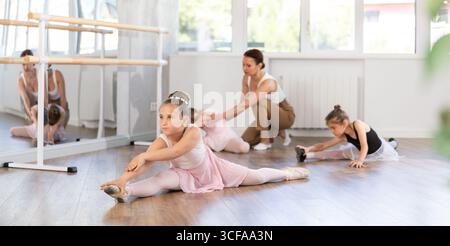 Group of girls doing splits in studio Stock Photo - Alamy