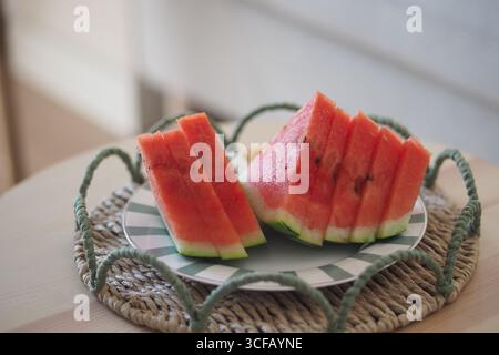 fresh watermelon slices arranged on serving plate with vibrant red ...