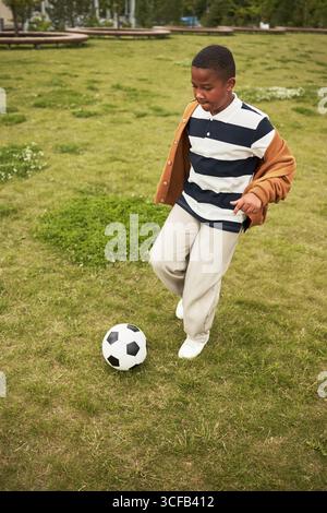 A school-age boy in a field with green soy. Country landscapes, agro ...
