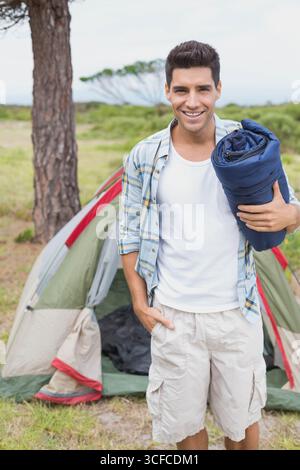 Man in sleeping bag holding cup Stock Photo - Alamy
