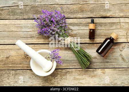 Flat lay composition with lavender flowers and natural essential oil on ...