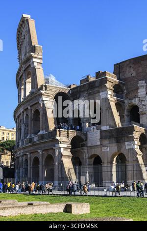 Exterior view of a large brick ruin with arched openings and an olive ...