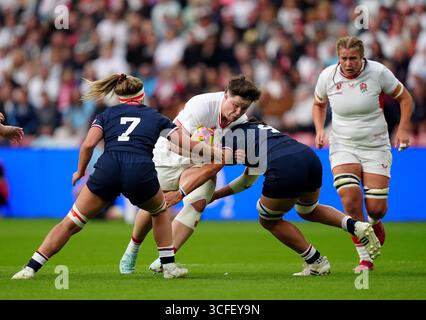 England's Hannah Botterman (centre) is tackled by Canada's Sophie de ...