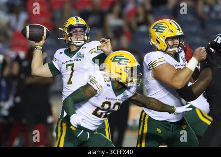 Edmonton Elks quarterback Cody Fajardo, left, looks for a receiver as ...