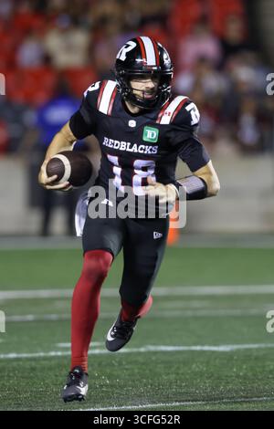 Ottawa Redblacks quarterback Dustin Crum (centre back) throws the ball ...