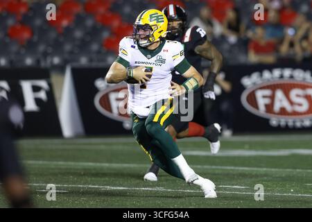 Edmonton Elks quarterback Cody Fajardo, left, hands off to Justin ...