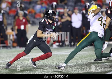 Ottawa Redblacks quarterback Dustin Crum (18) gets tackled by B.C ...