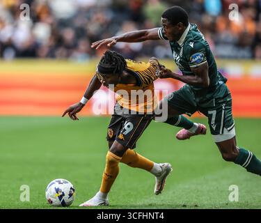 Joel Ndala of Hull City is fouled by Morgan Whittaker of Middlesbrough ...