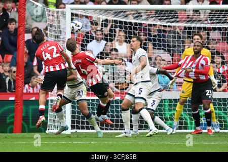 Sheffield United's Tyler Bindon (left) fouls Wrexham's George Thomason ...