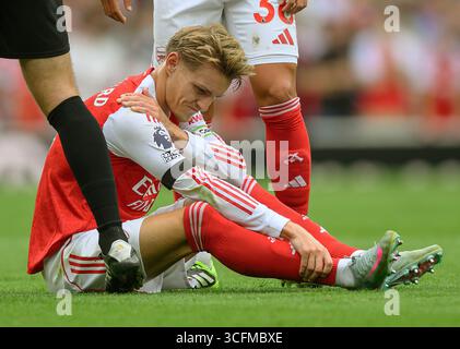 Martin Odegaard of Arsenal goes down with injury during the Premier League match Arsenal vs ...